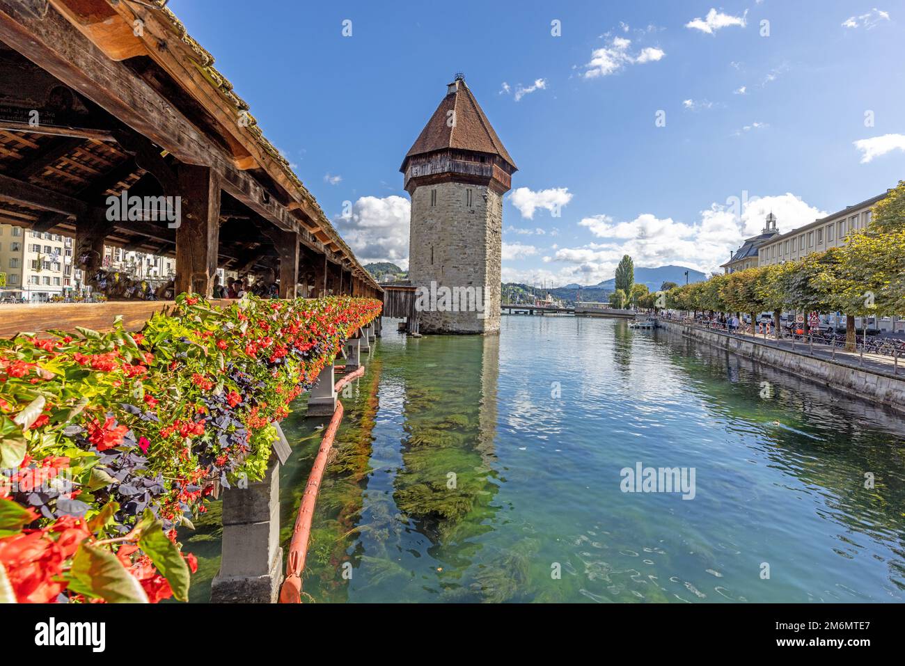 View along the flower-covered Chapel Bridge in Lucerne over the Reuss ...