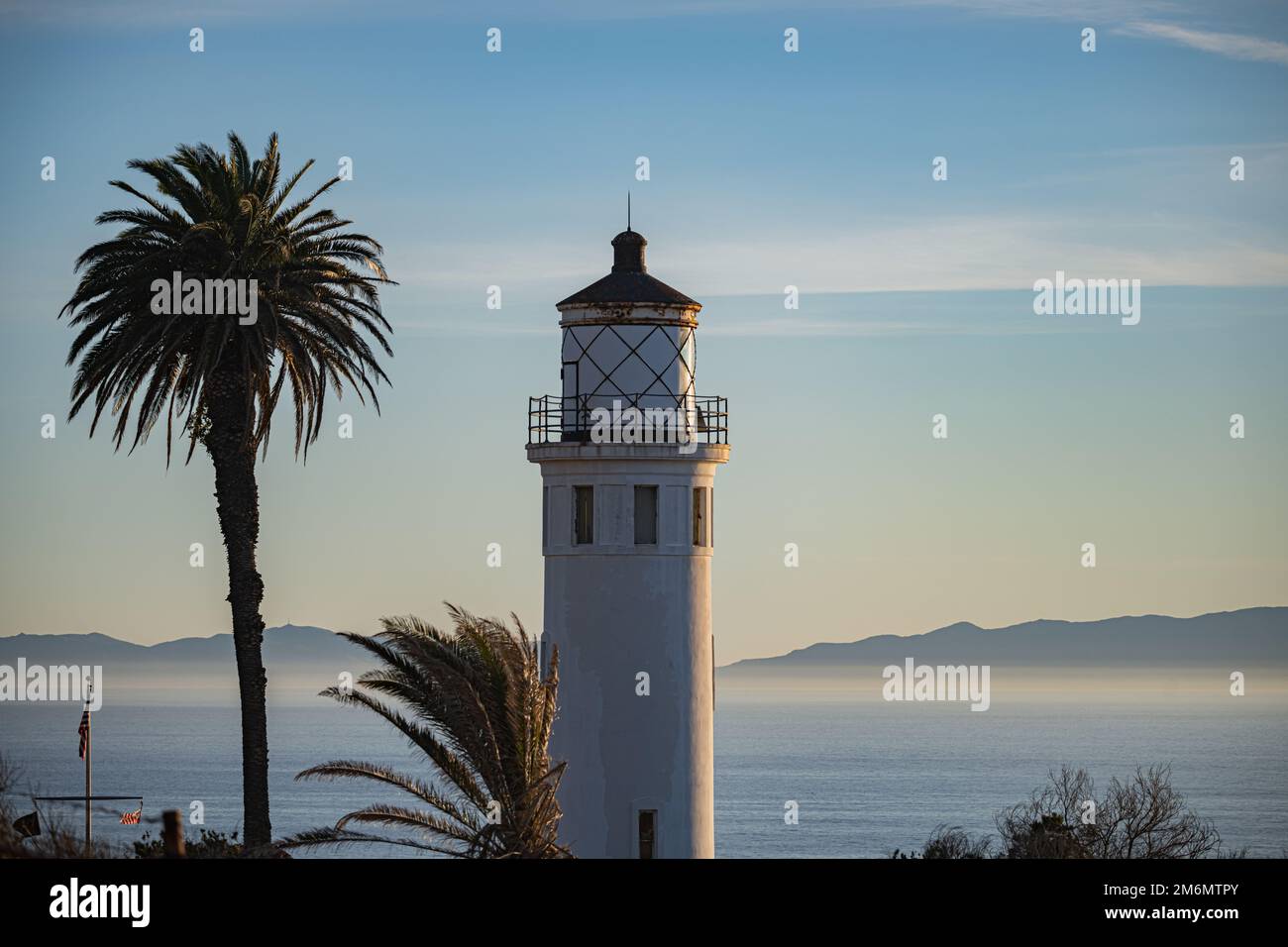 A lighthouse on the shore at sunset Stock Photo - Alamy