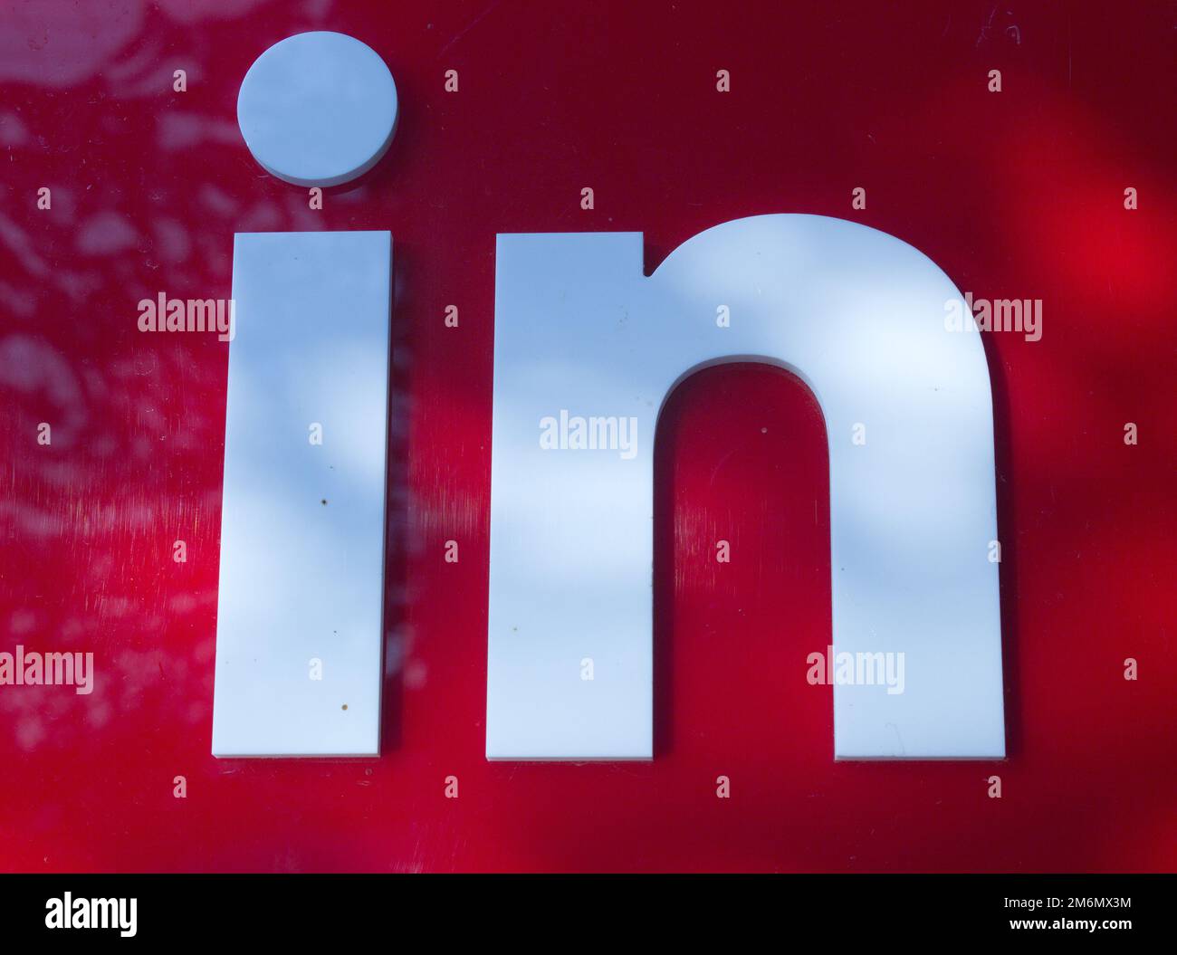 White "in"-sign on blood red background showing way into building or ...