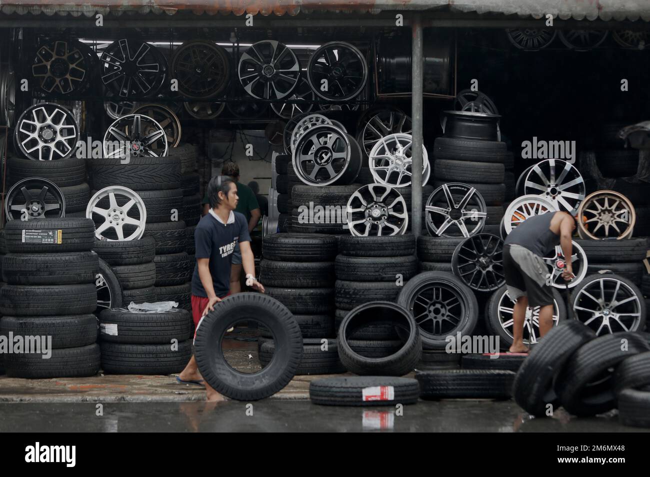 January 5, 2023, Manila, Manila, The Philippines: Workers repair tyres ...
