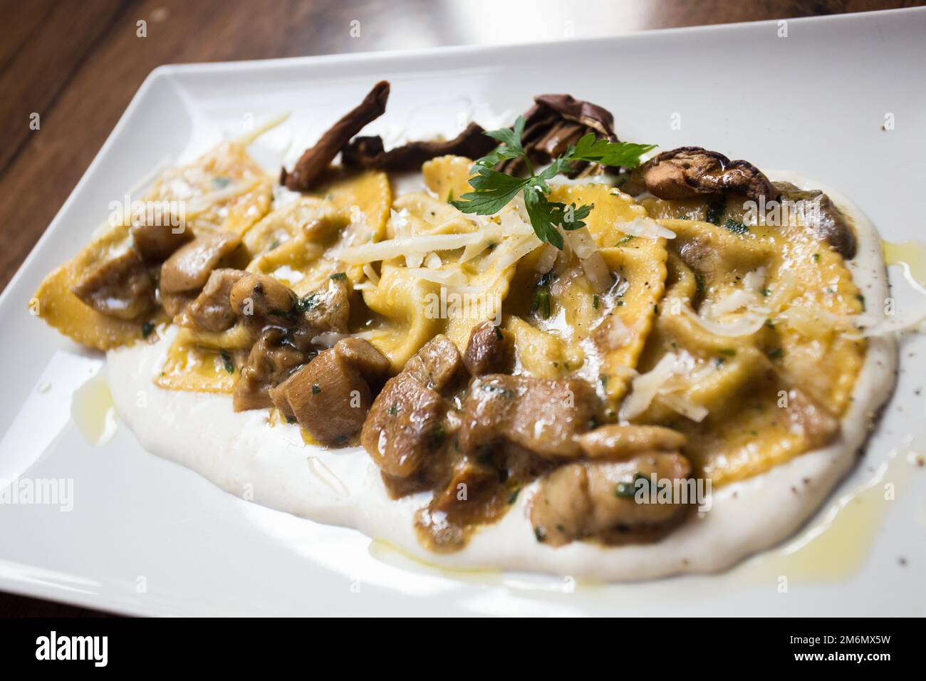 Agnolotti pasta stuffed with meet cooked with sauce and mushrooms ...