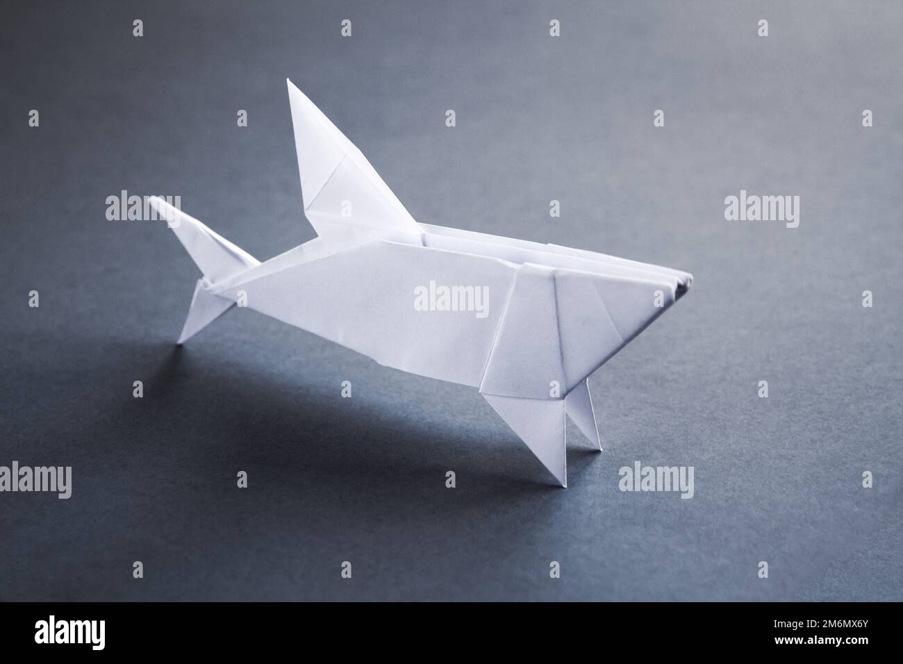 White paper shark origami isolated on a grey background Stock Photo - Alamy