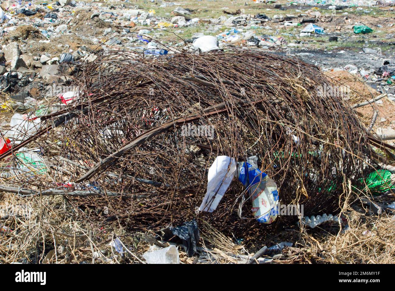 stock photo of rusted wire roll on waste dump site amongst plastic and ...