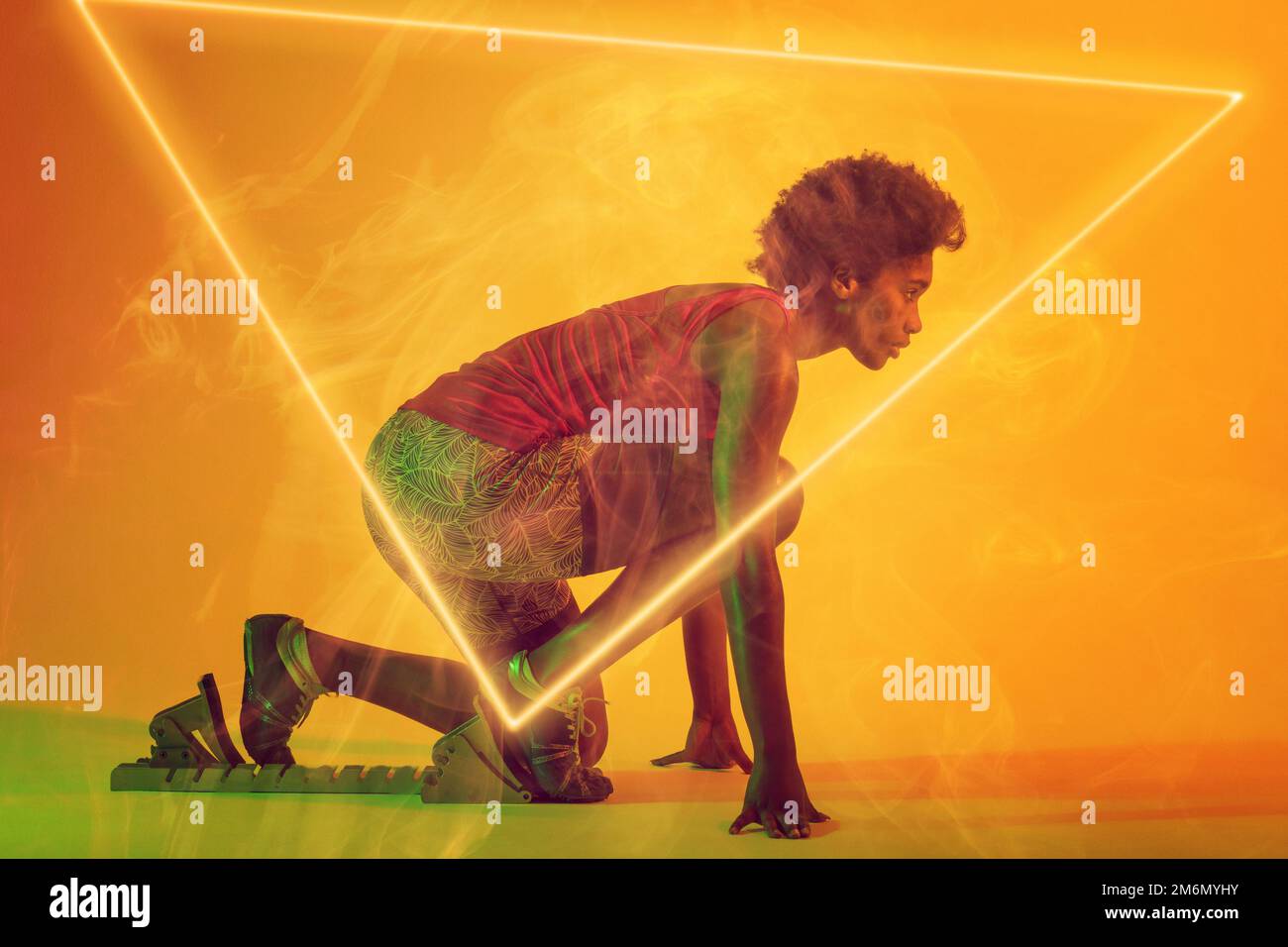 Side view of african american female athlete at starting position by ...