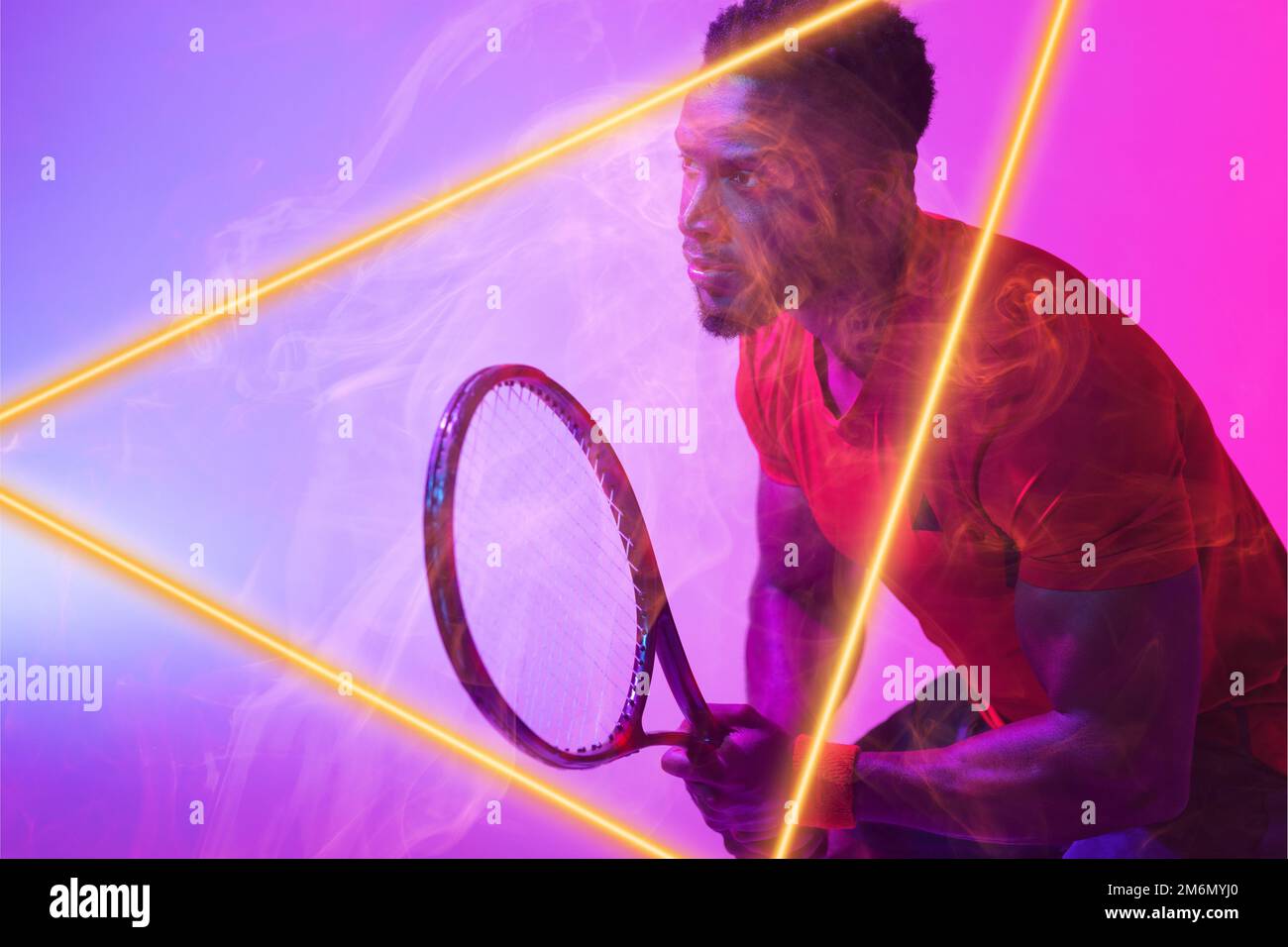 African american male tennis player with racket by illuminated triangle ...