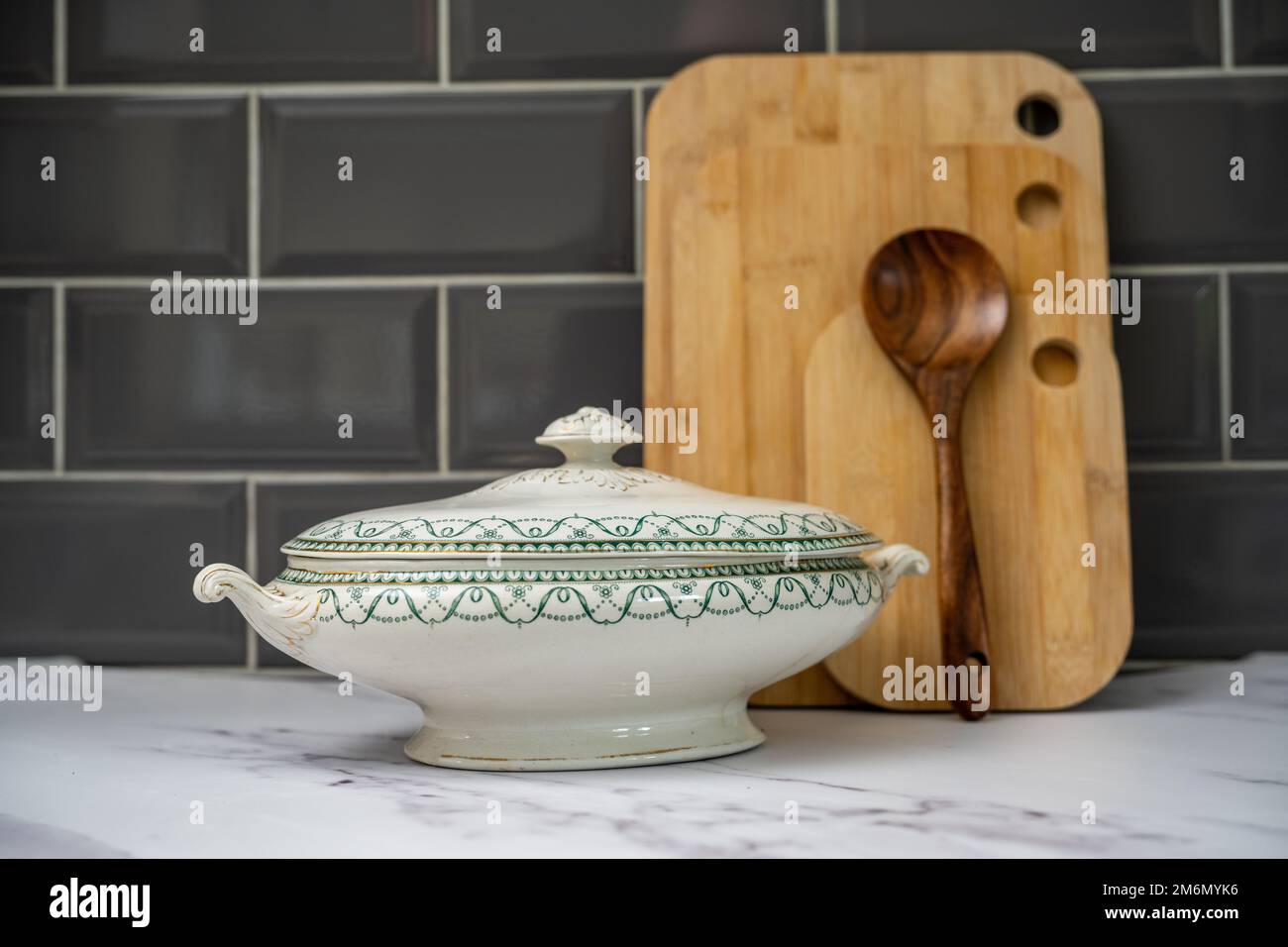 selected focus on a large antique tureen for vegetables soups food on a ...