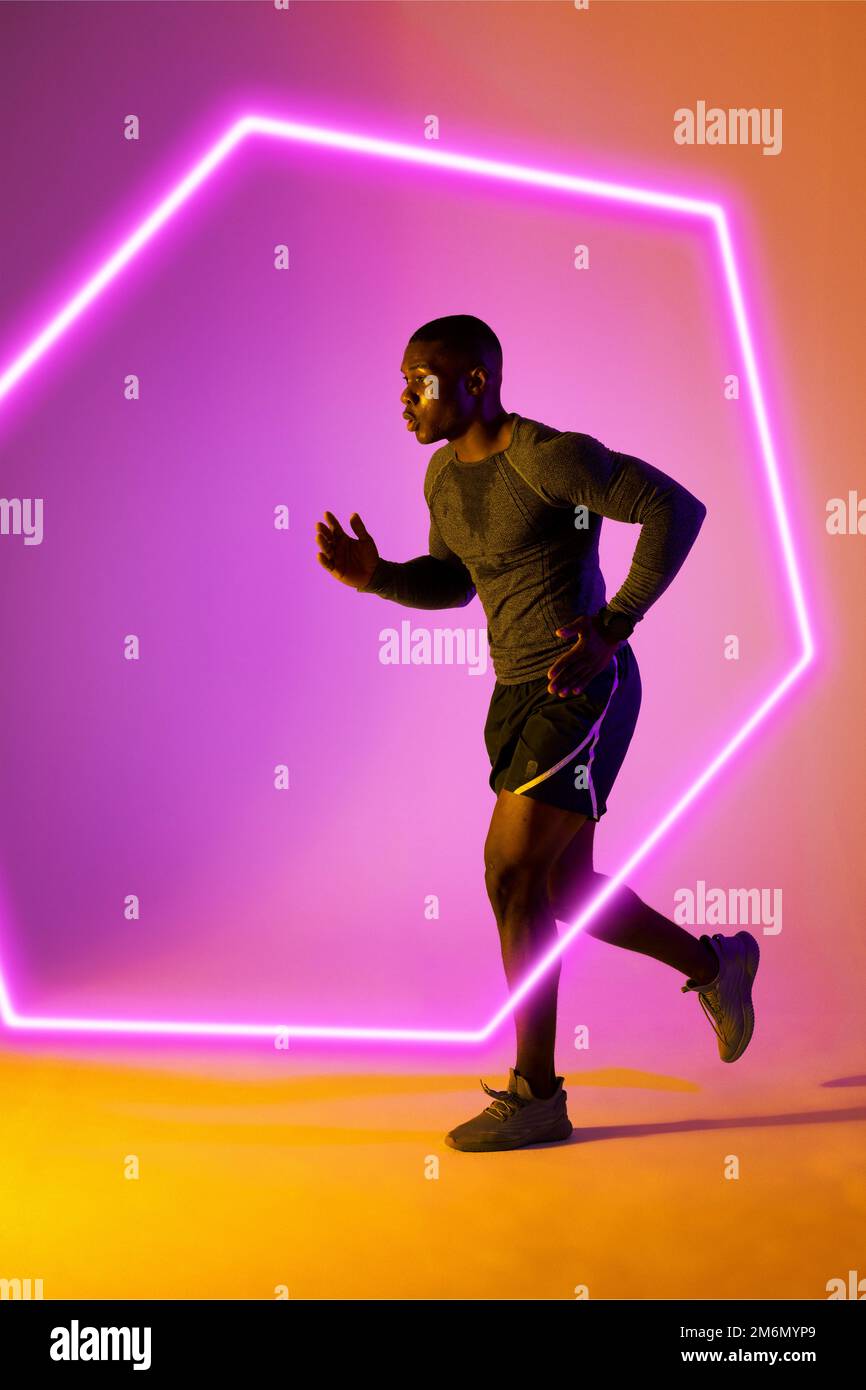 African american male athlete running over illuminated hexagon against ...