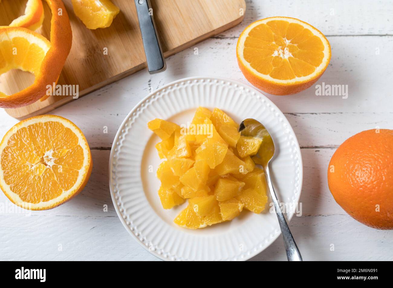 Chopped or diced oranges on a white plate for healthy snack or dessert ...
