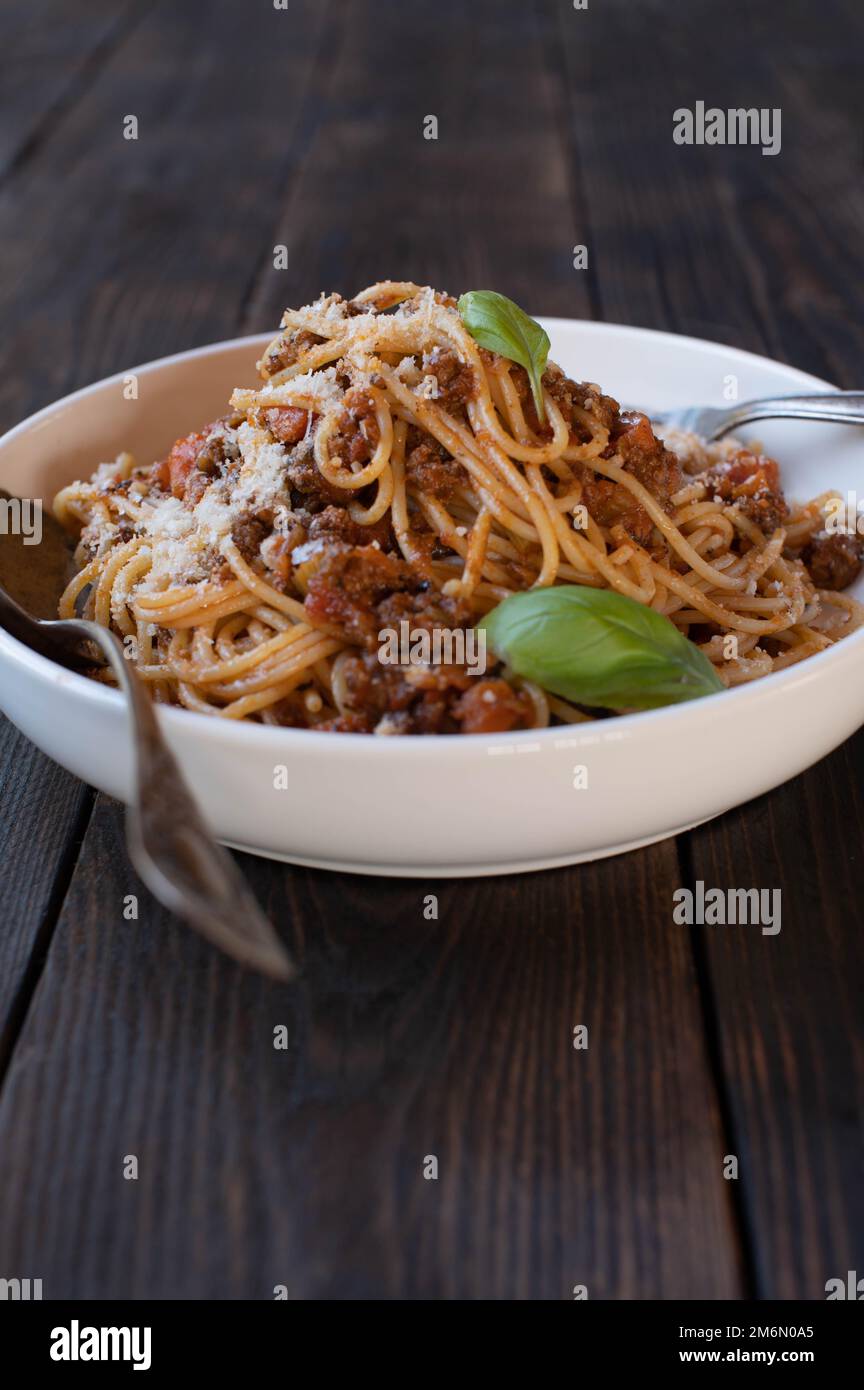 Plate with spaghetti bolognese, parmesan cheese and basil leaf isolated ...