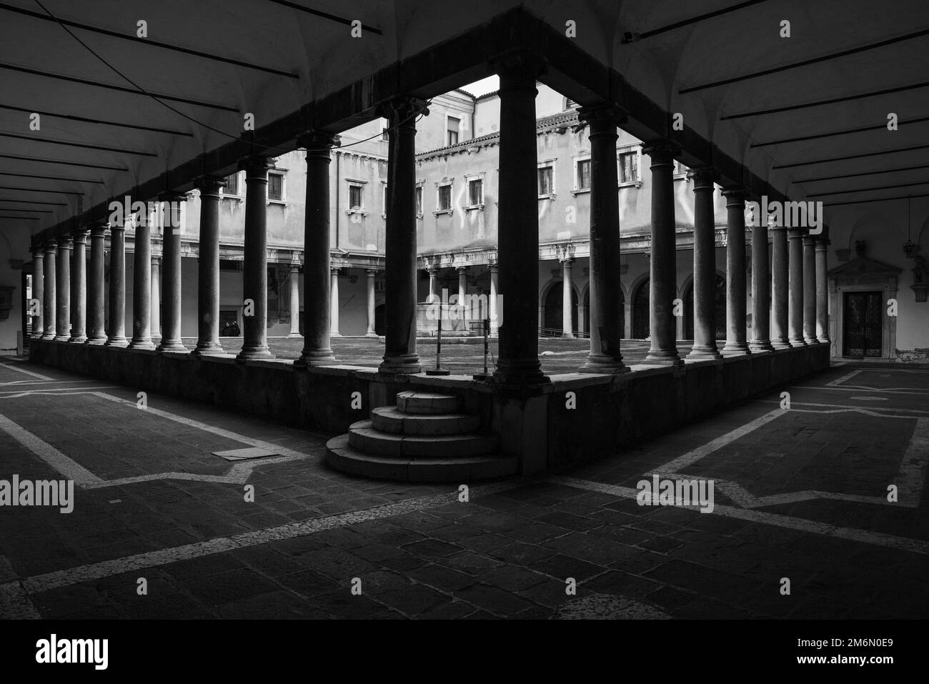 Inner court of an old Italian building with columns - black and white ...