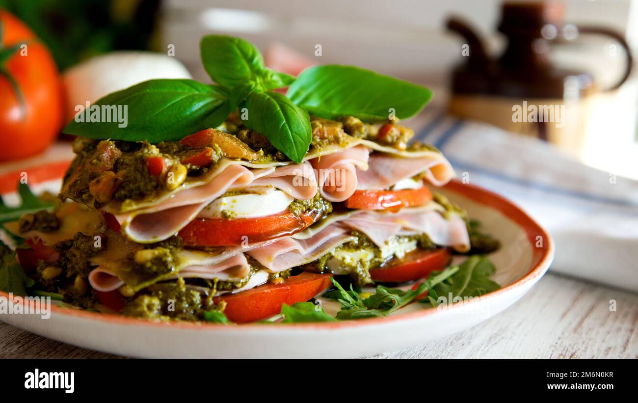 Cold lasagna with tomato and pesto. Lasagna is a type of pasta. It is ...