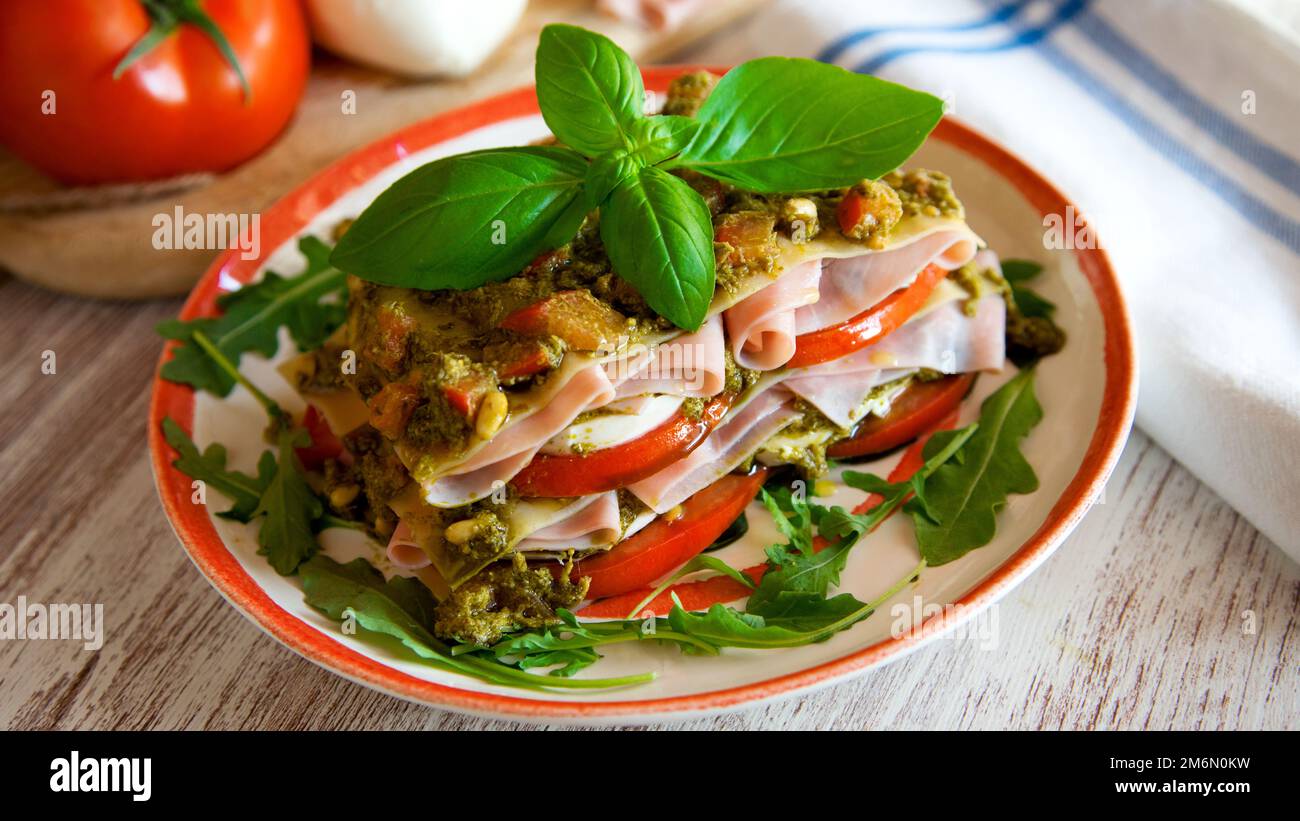 Cold lasagna with tomato and pesto. Lasagna is a type of pasta. It is ...