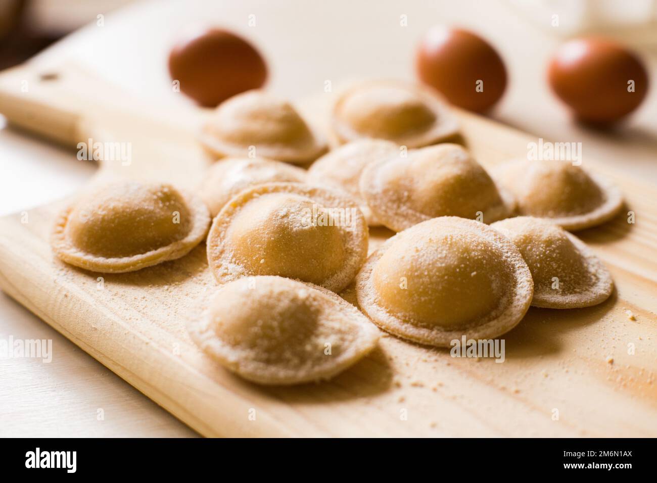 Italian fresh pasta. Panzerotti on a wooden board Stock Photo - Alamy