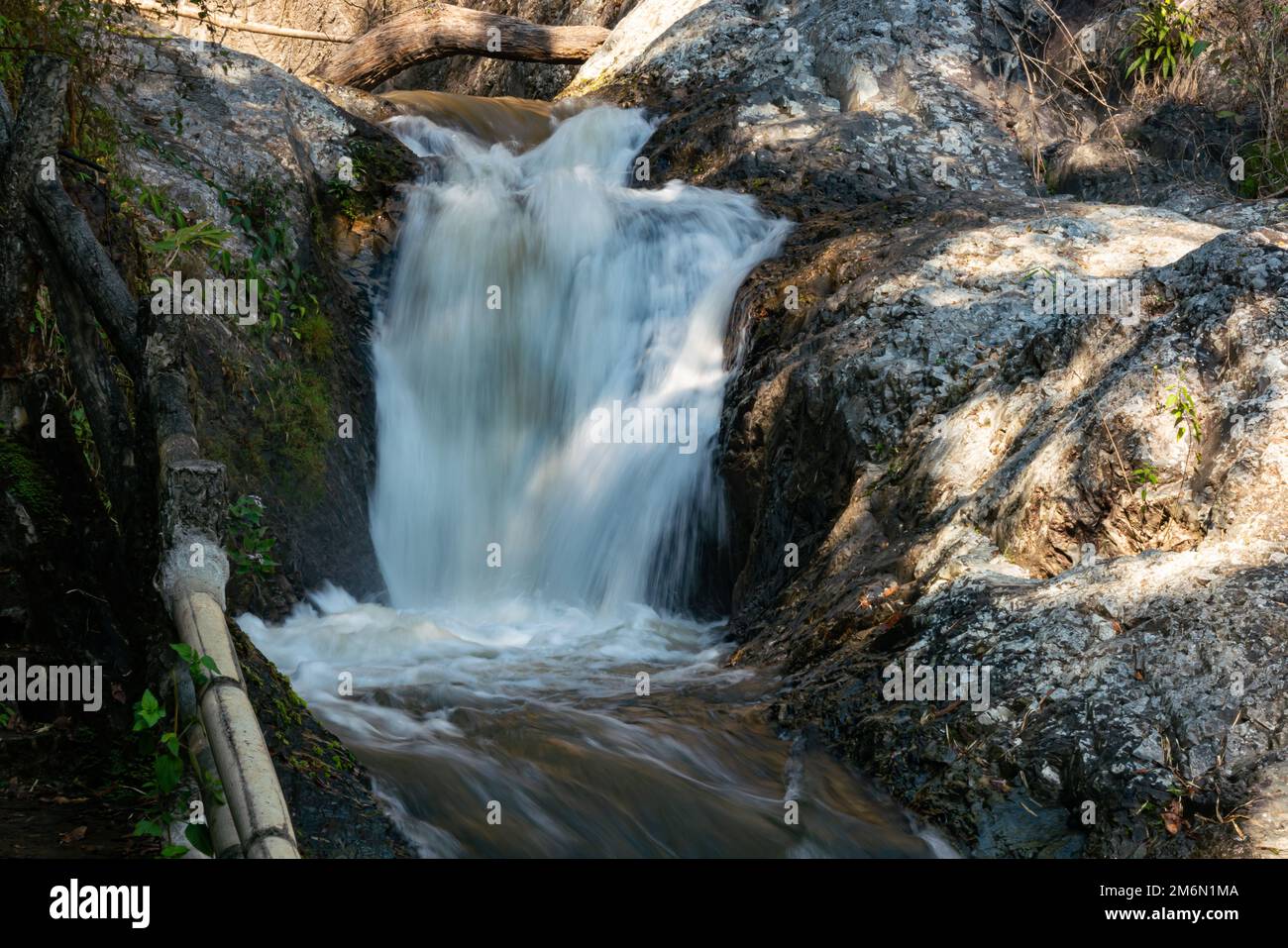 Natural clear mountain stream water flowing down over boulders in the ...