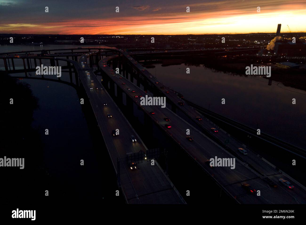 Commuters make their way along the 395 highway as the sun sets ...