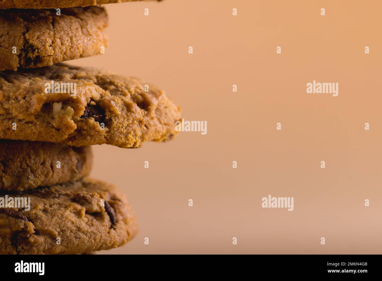 Close-up of stacked cookies against brown background with copy space ...