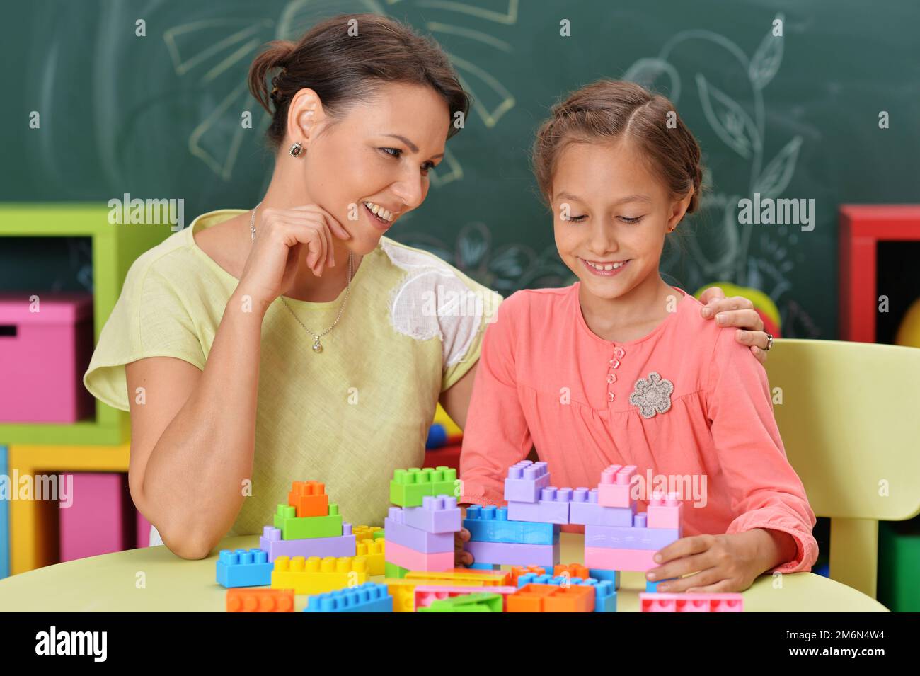 Girl playing with colorful clay blocks at home Stock Photo - Alamy