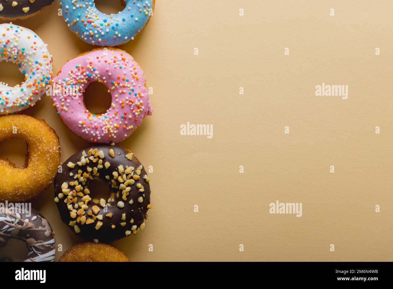 Directly above view of fresh multi colored donuts by copy space on ...