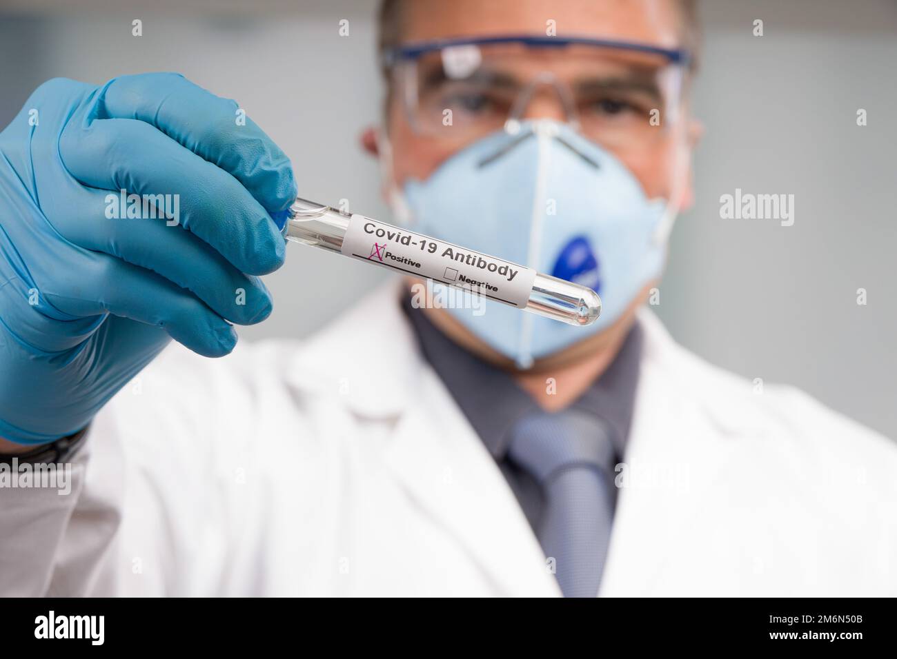 man with face mask is handling a probe tube Stock Photo - Alamy