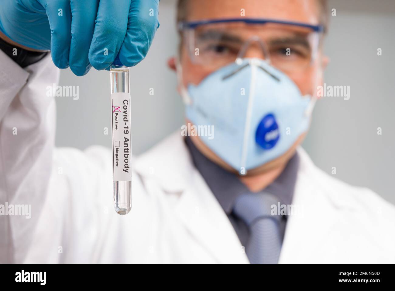 man with face mask is handling a probe tube Stock Photo - Alamy