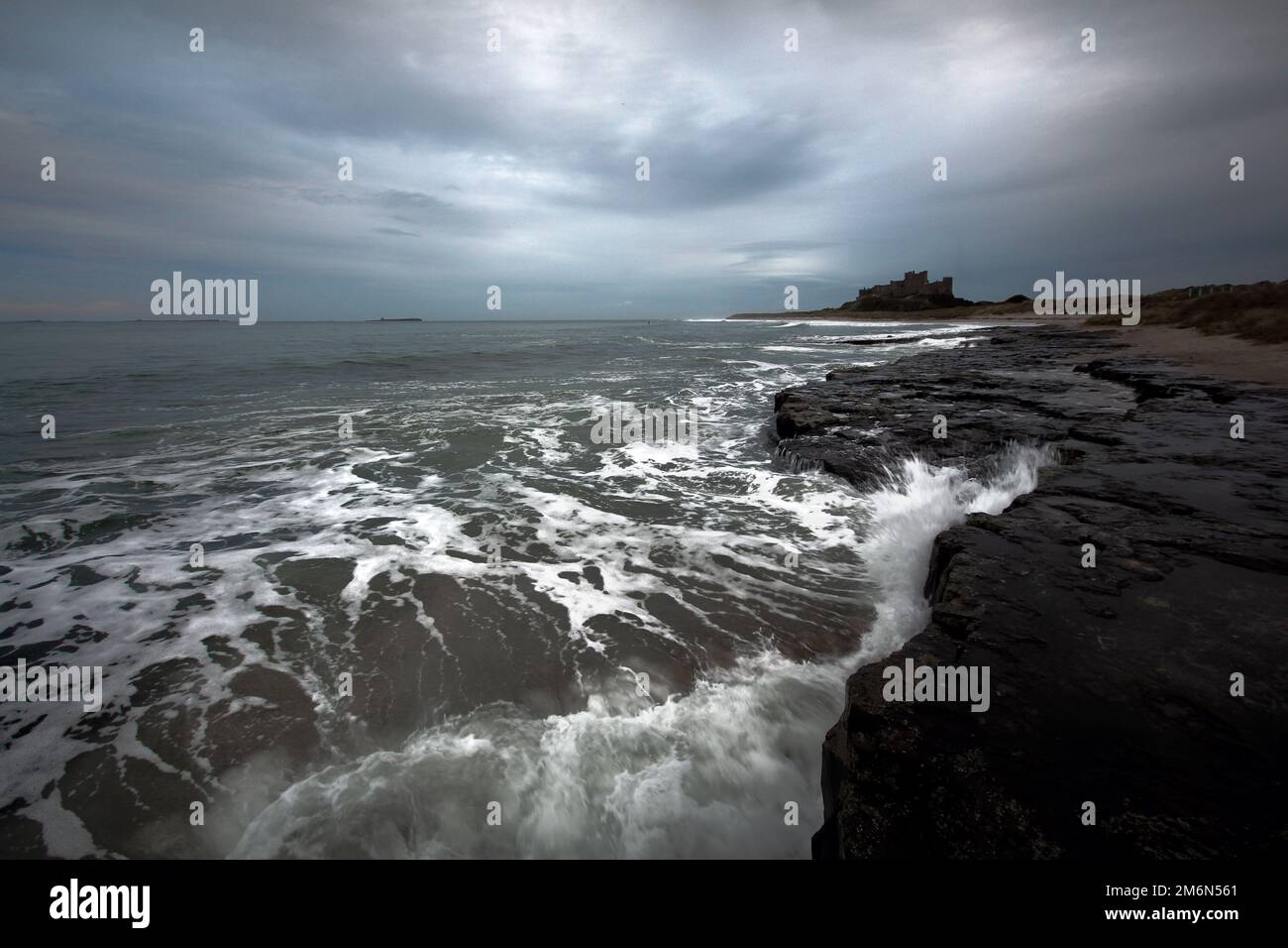 Bamburgh castle with strong sea Stock Photo - Alamy