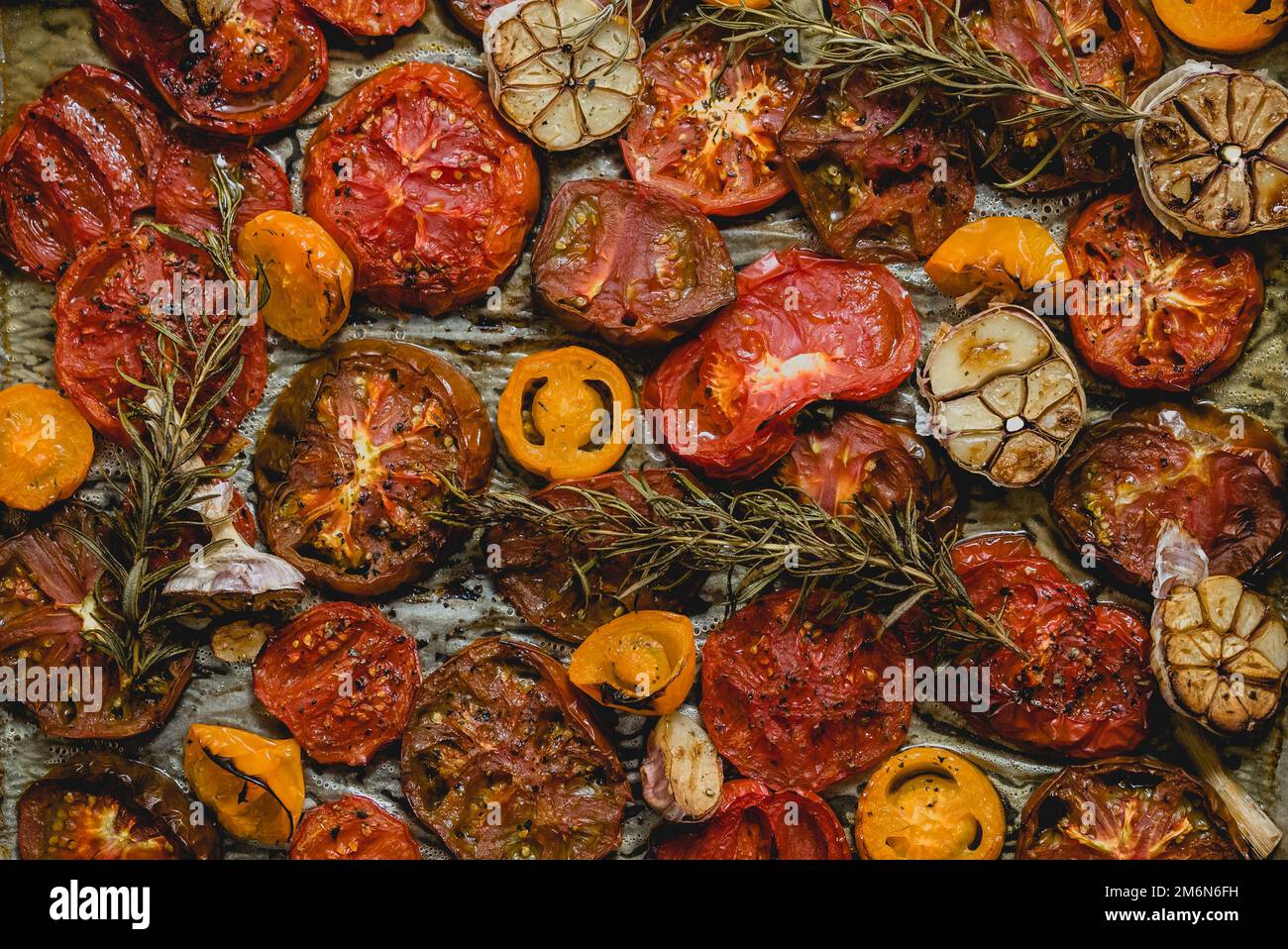 Various kinds of roasted red and yellow tomatoes with thyme and garlic ...