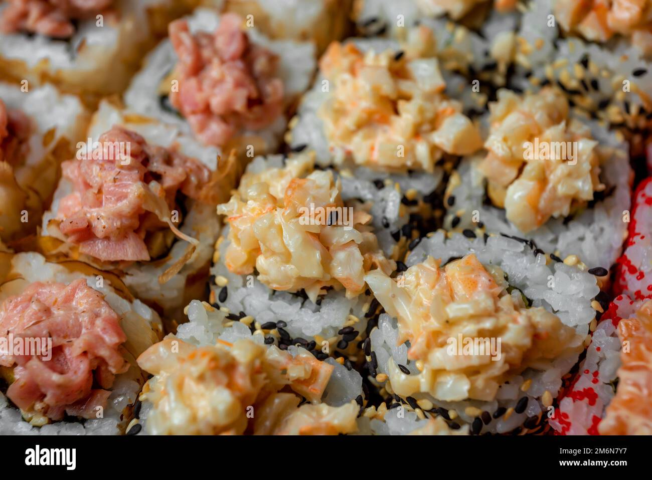 Japanese national dish of sushi, rolls with red fish and salmon chips ...
