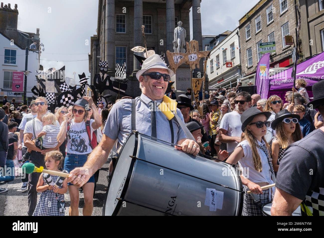A mature man drumming in the parade in the Mazey Day celebrations as ...