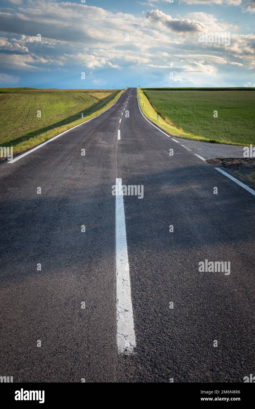 The concrete road leading through the countryside environment with ...