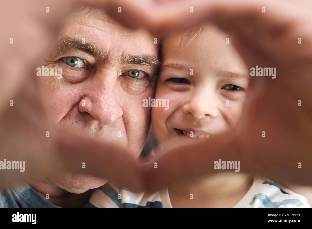 Grandfather and Grandson Making a Heart Shape Hand Gesture Together ...