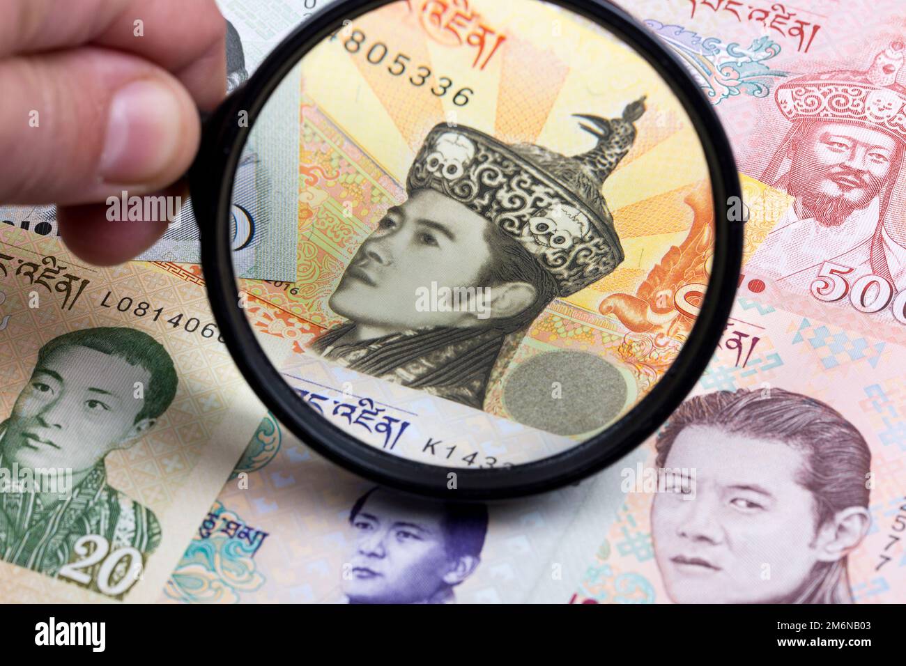 Bhutanese ngultrum in a magnifying glass Stock Photo - Alamy
