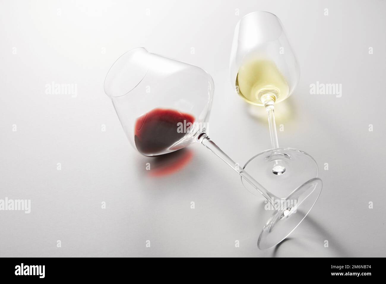 Little red, white wine is poured into stem glasses Stock Photo - Alamy