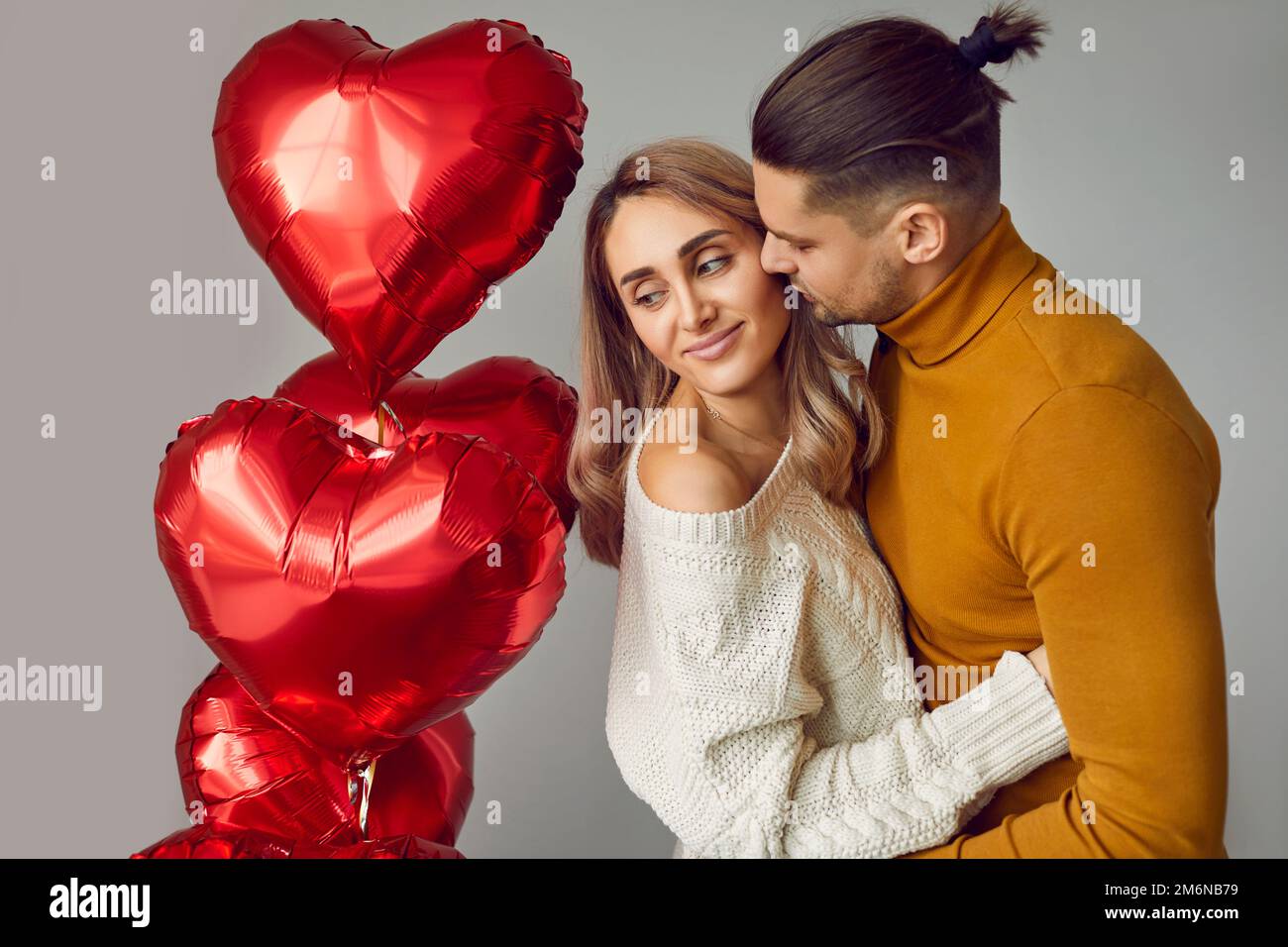 Young, beautiful, in love couple in a romantic atmosphere hugging among ...