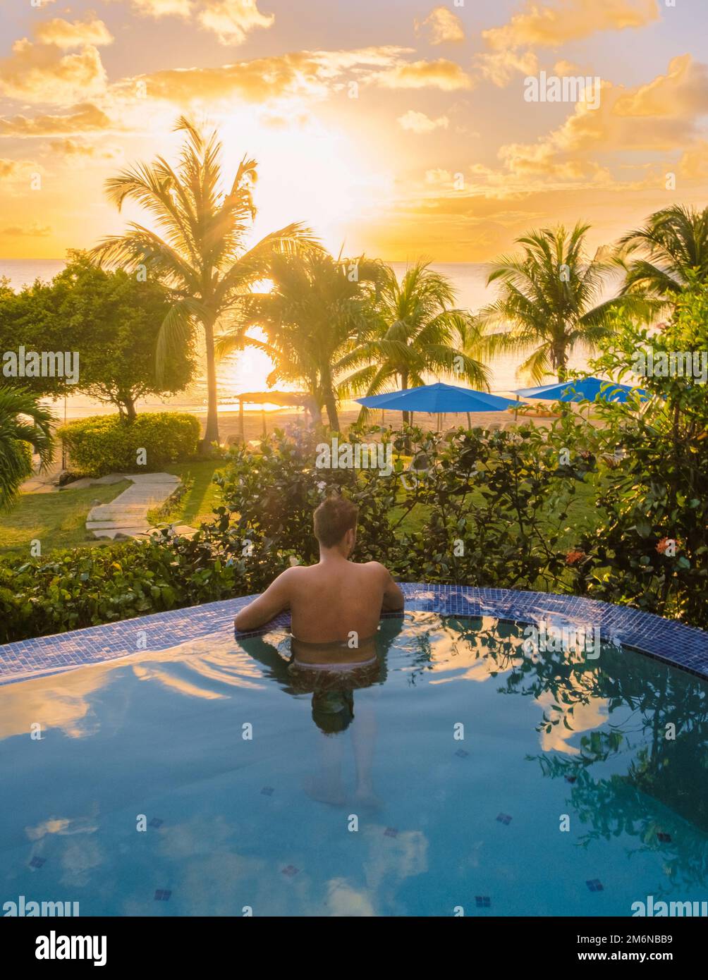 Young men in swim short at Saint Lucia Caribean, men at infinity pool ...