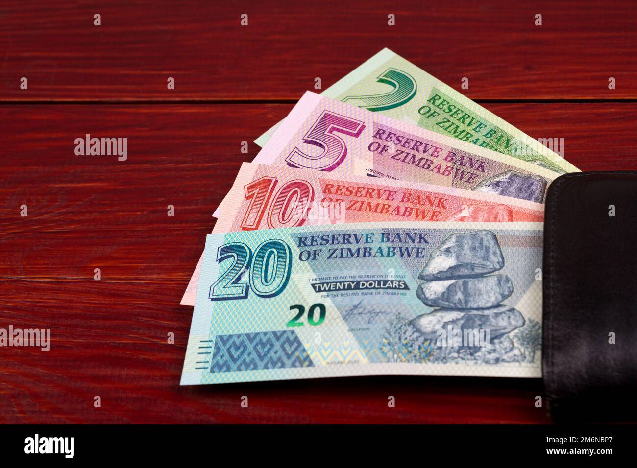 New serie of Zimbabwean banknotes in the black wallet Stock Photo - Alamy