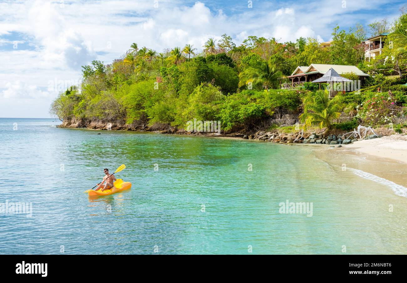 Young men in kayak at a tropical island in the Caribbean sea, St Lucia ...