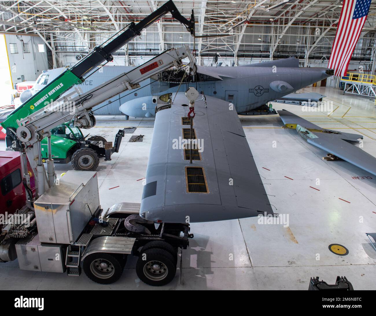 The wing of a C-130H Hercules transport plane being removed by crane ...