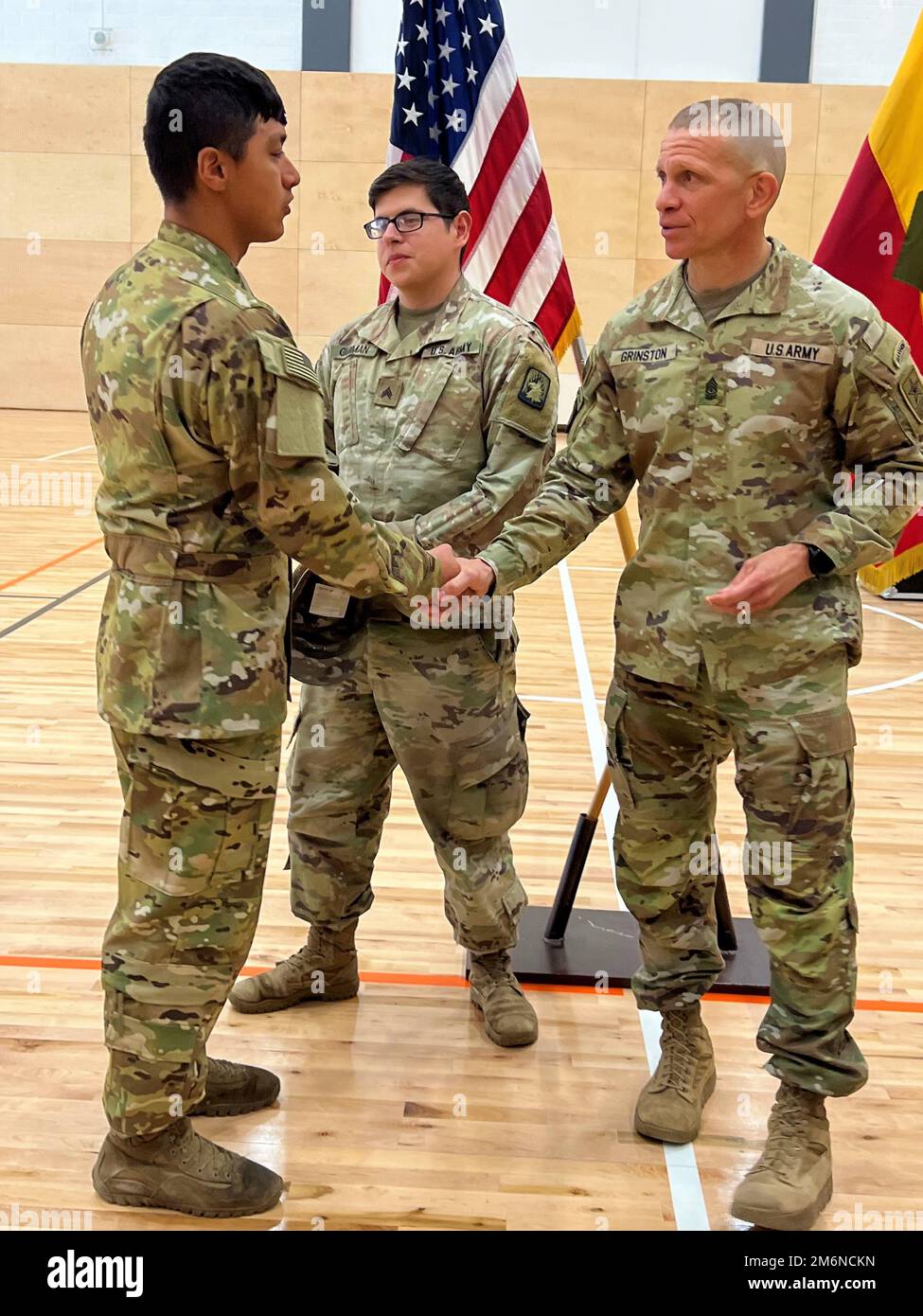 Sgt. Maj. of the Army Michael Grinston (third from left) shakes hands ...