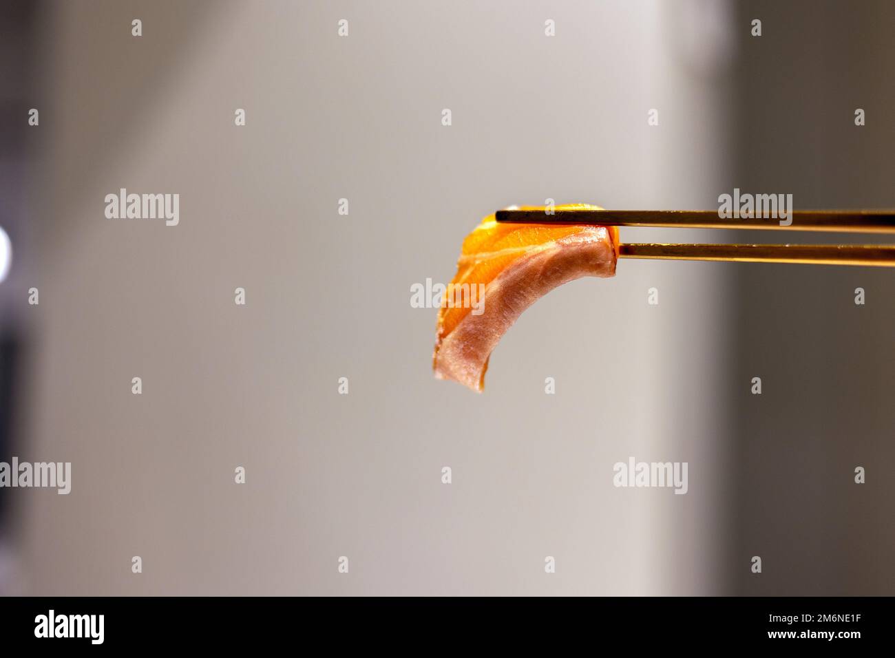 Picking up salmon with chopsticks Stock Photo - Alamy