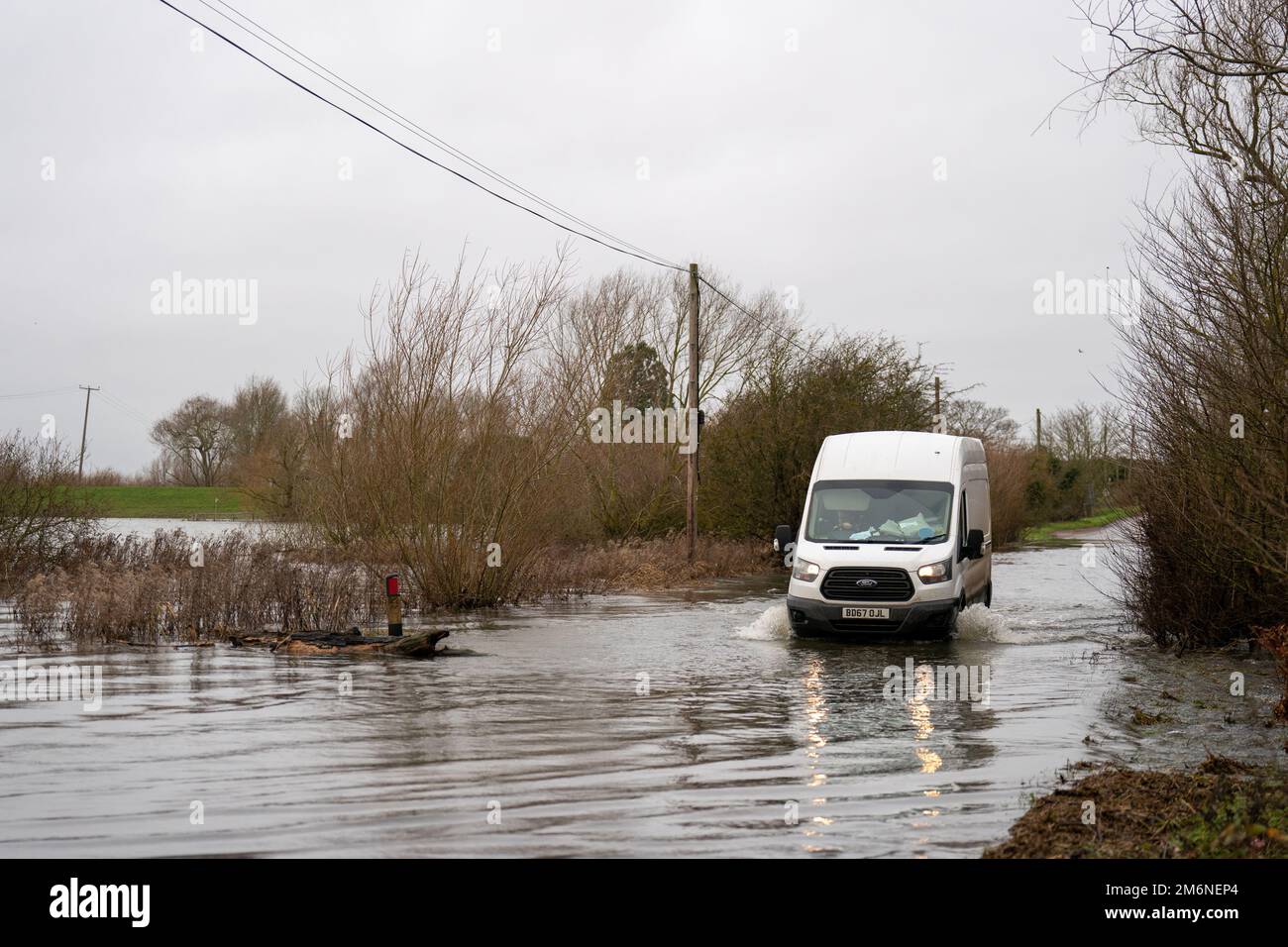A van drives along a flooded road in Sutton, Cambridgeshire, where the ...
