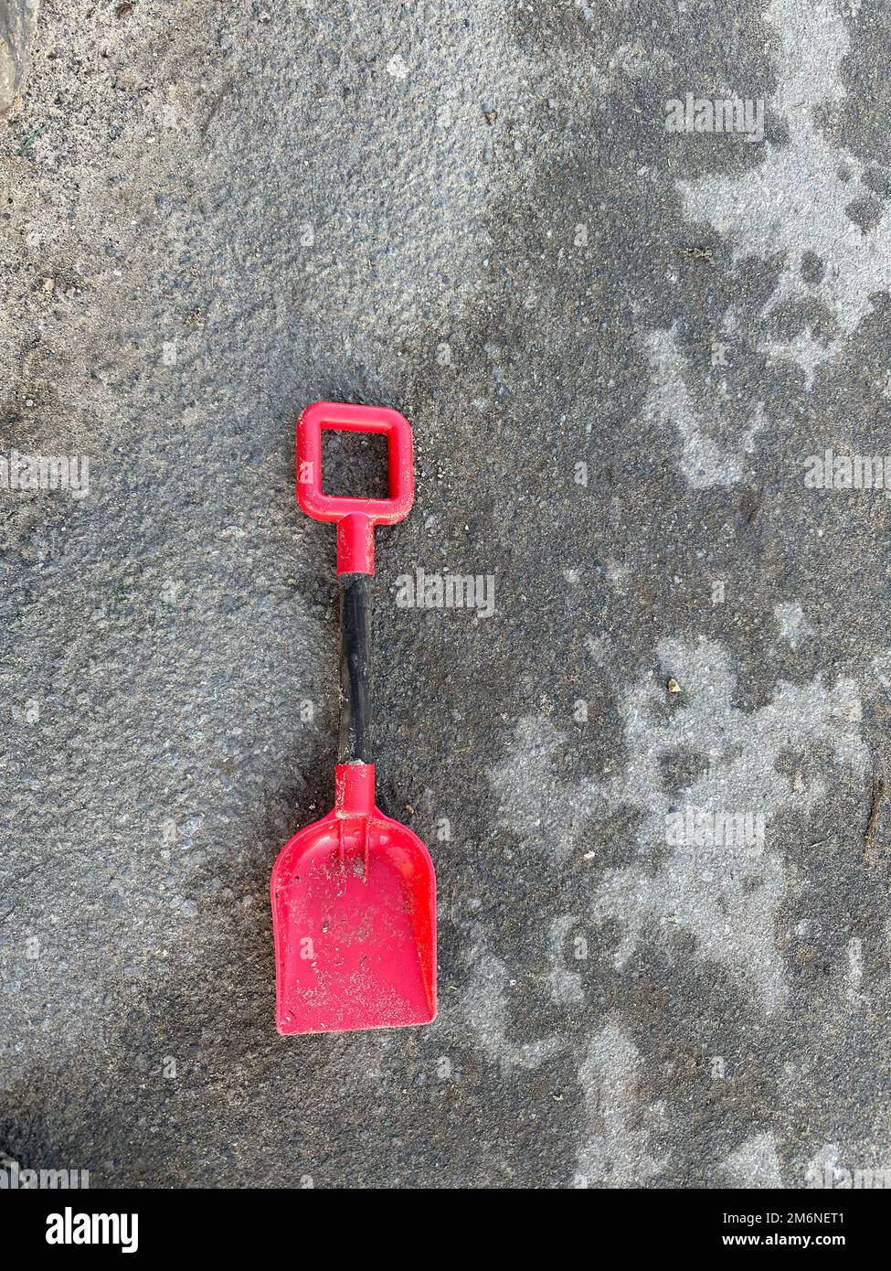 red child spade on concrete path Stock Photo - Alamy