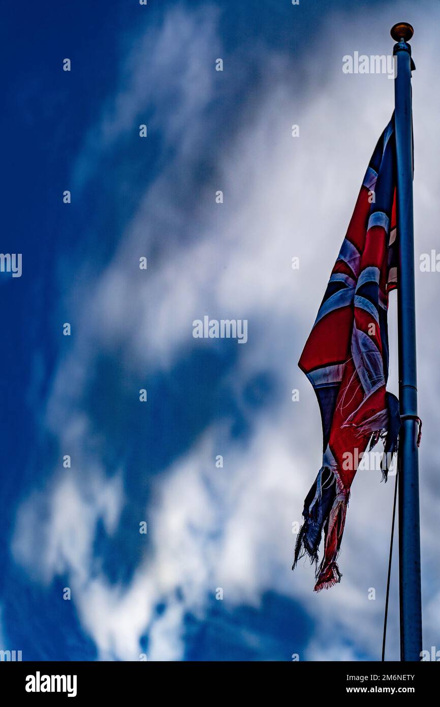 Torn and tattered Union Jack flag against blue cloudy sky Stock Photo ...