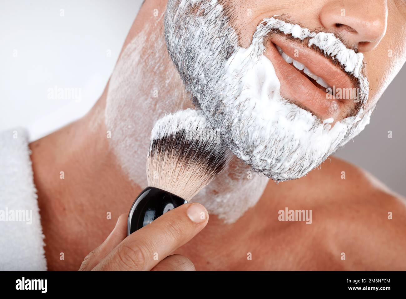 Closeup, man and brush for shaving cream in studio for self care ...