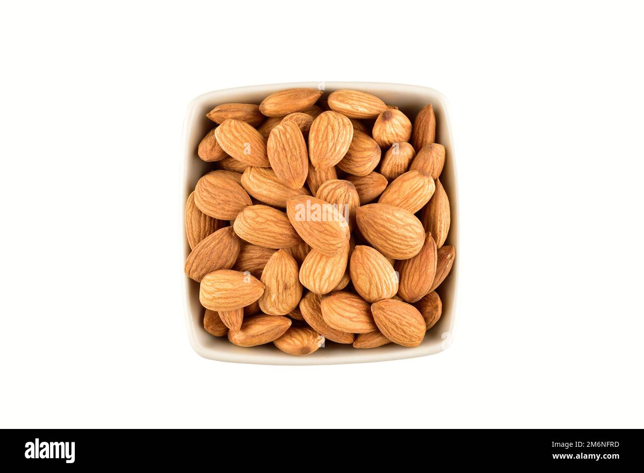top view of almond in bowl isolated on white background Stock Photo - Alamy