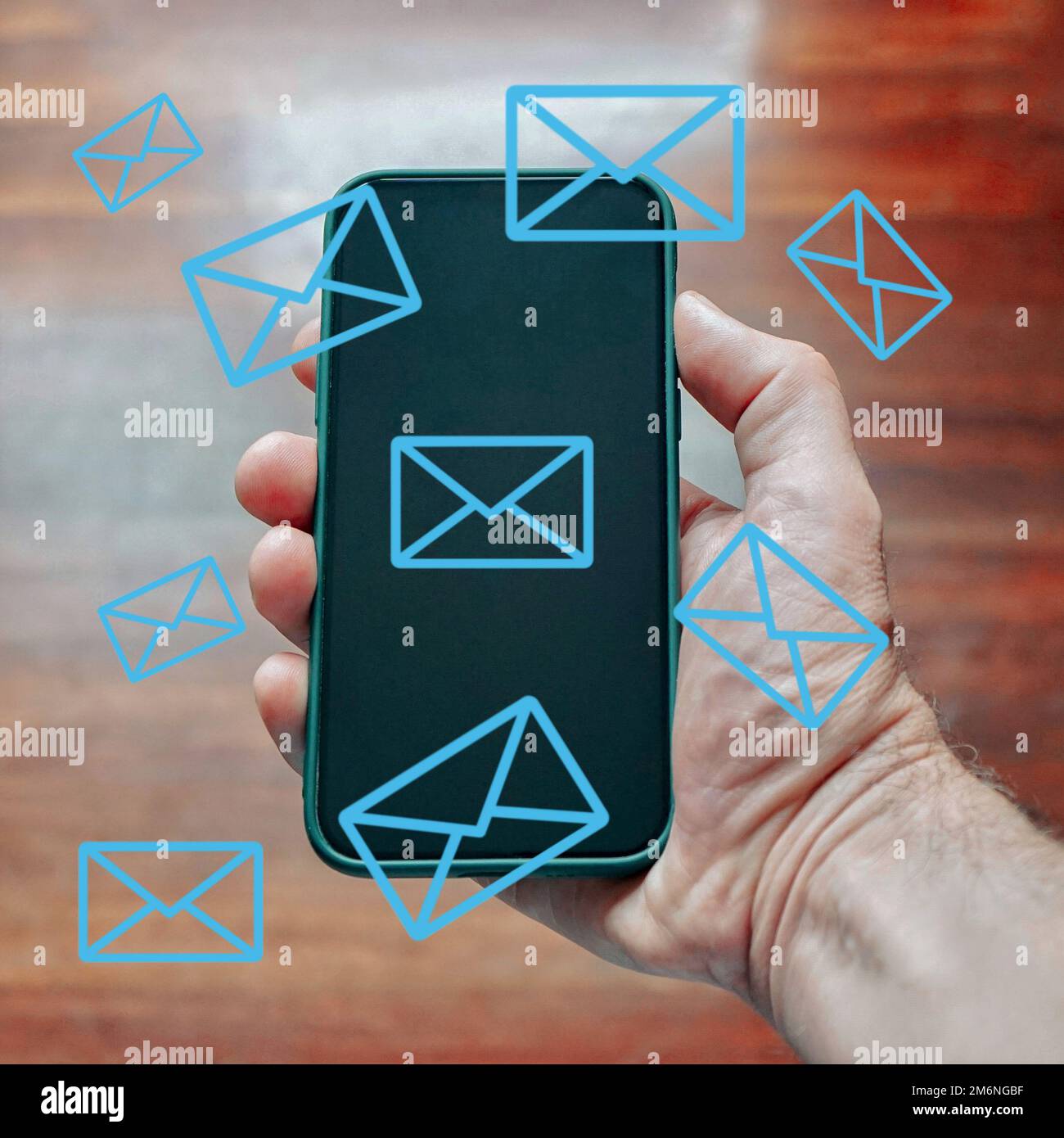 hand holding a mobile phone with email simbol, Telecommuting and e-work ...