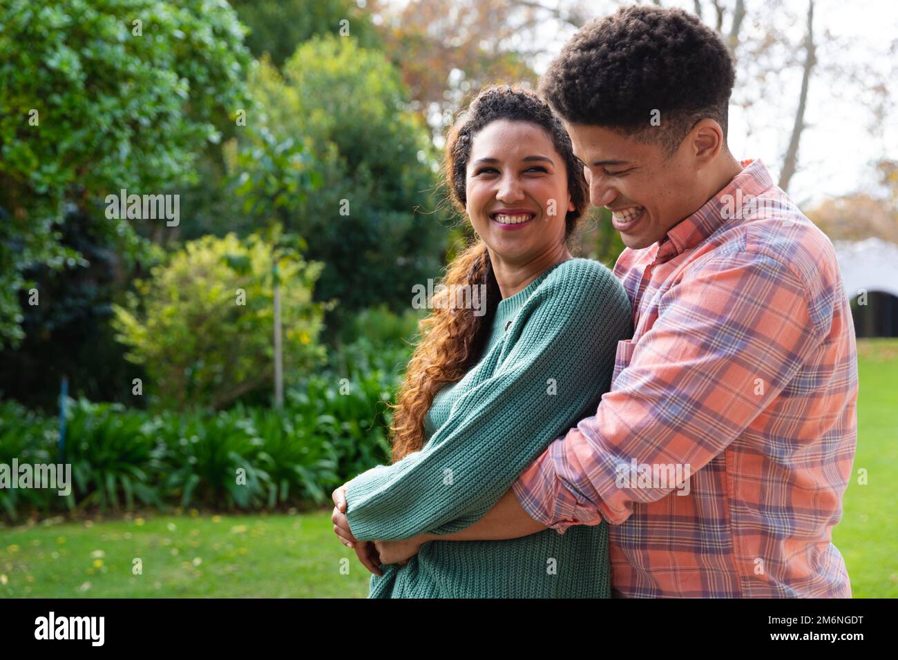 Happy biracial couple embracing hi-res stock photography and images - Alamy