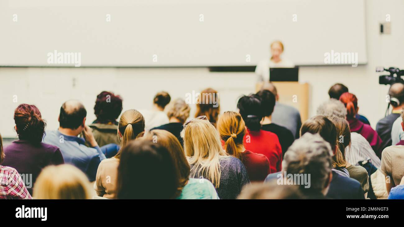 Business and entrepreneurship symposium. Female speaker giving a talk ...