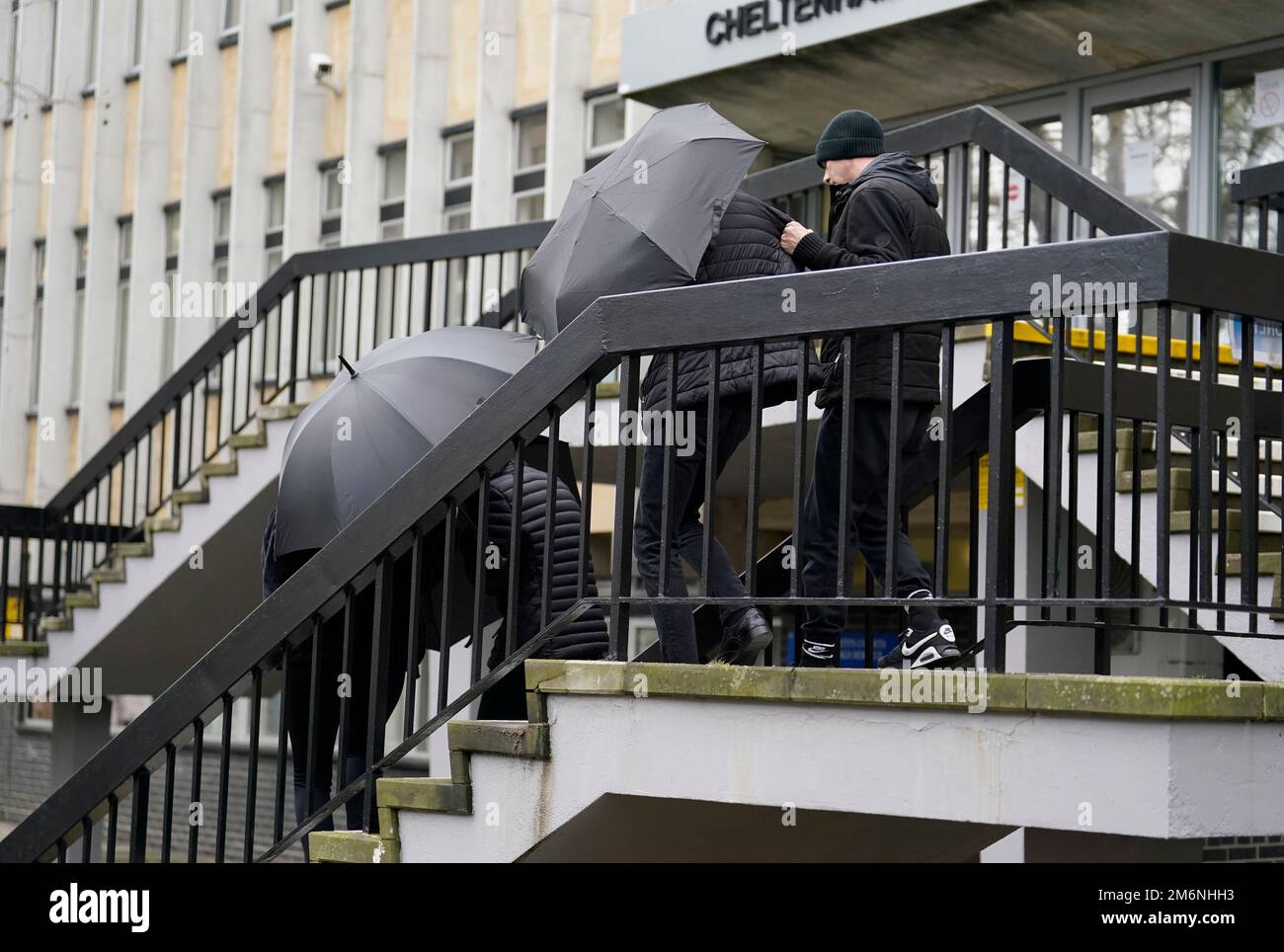 Elliot Benham, 23, (second right under umbrella) and Sophie Harvey, 23 ...