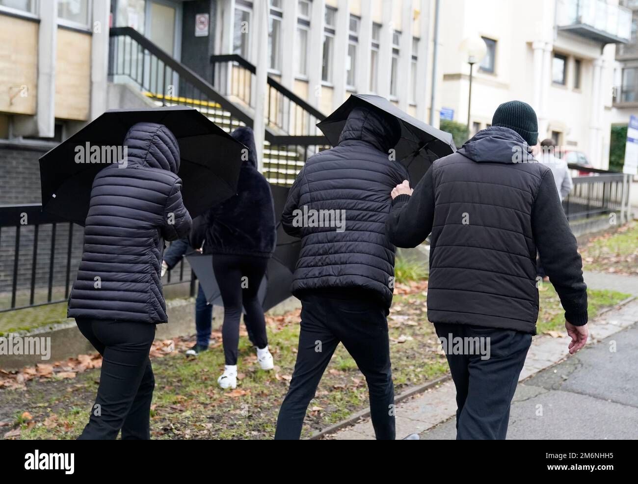 Elliot Benham, 23, (second right under umbrella) and Sophie Harvey, 23 ...