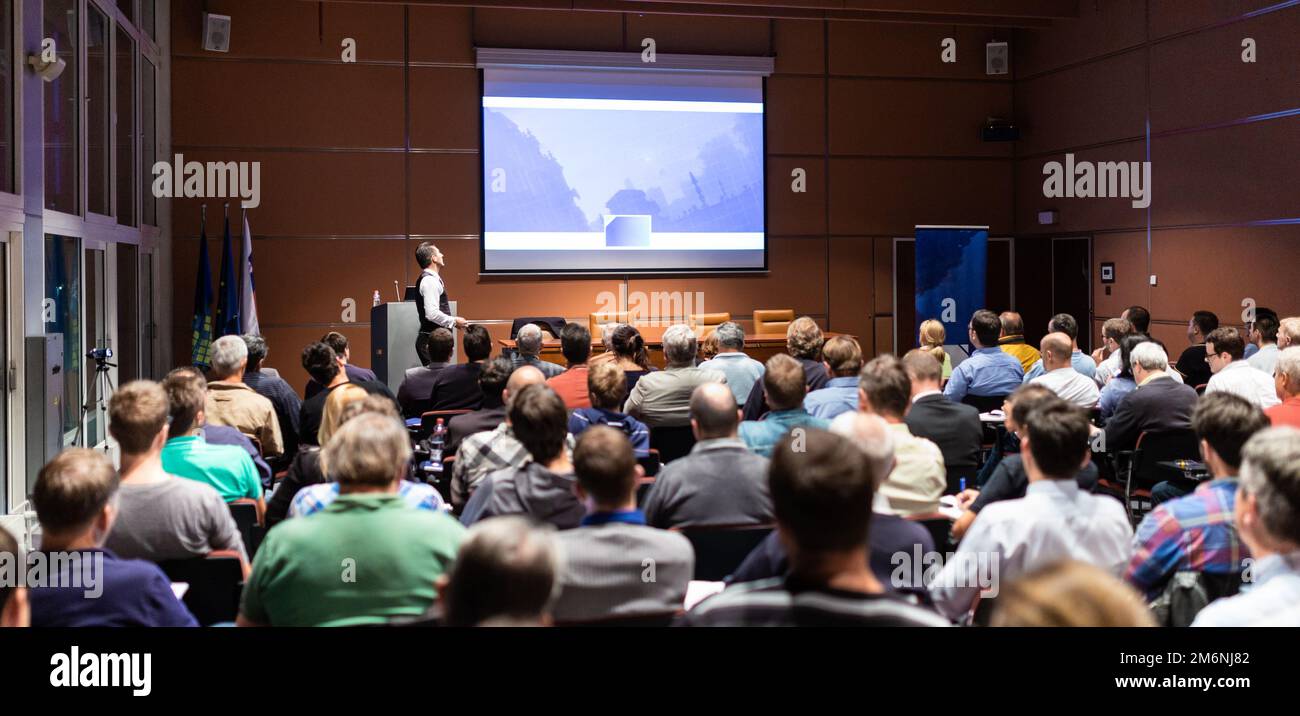 Speaker giving a talk in conference hall at business meeting event ...